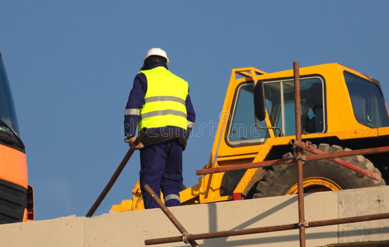 Workers in Yellow at the Construction Site Work on Scaffolding Stock ...