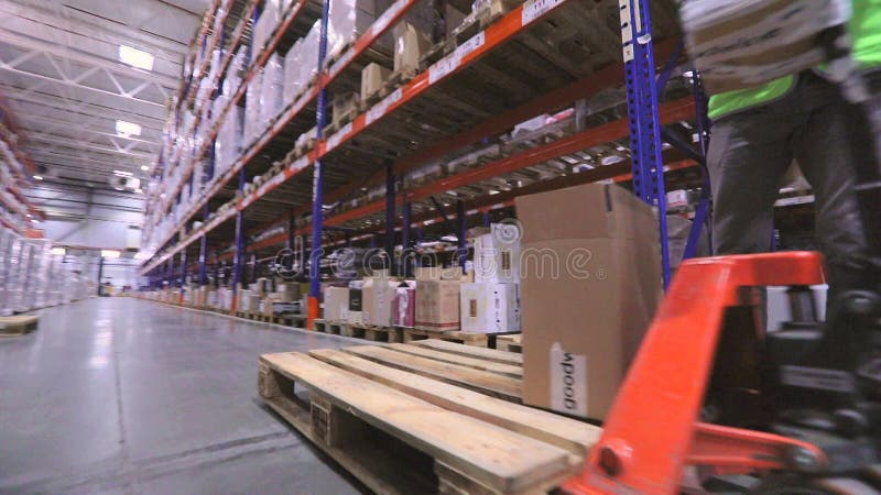 Workflow in a Modern Warehouse. Worker on a Modern Forklift. Working in ...