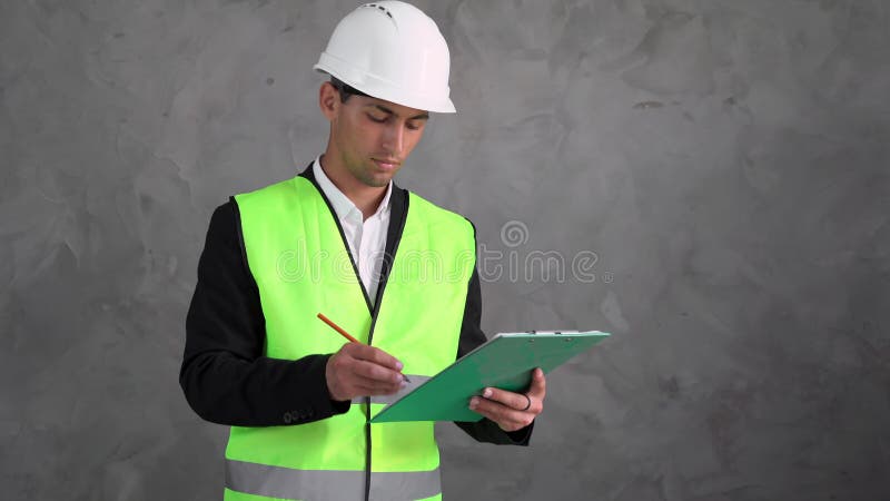 Working Arab Civil Engineer Using a Tablet Planning a Project, Building ...