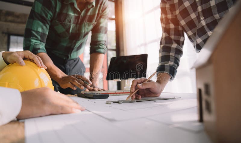 Working As a Team Architect and Designer Working on Blueprint Project of New Apartments. Photo ...