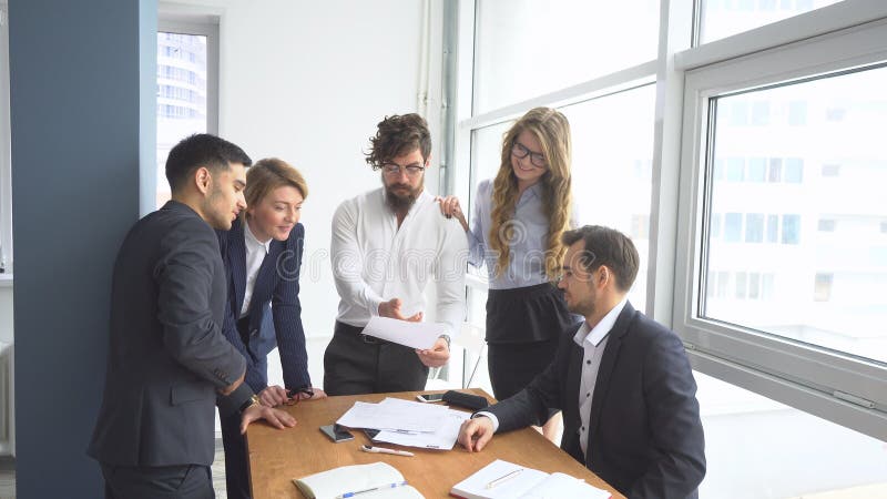 Working Atmosphere in the Office. Employees To View Documents in the ...