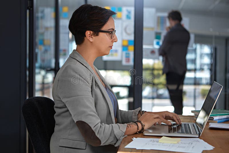 Working Away. a Businesswoman Working in Her Office. Stock Photo ...