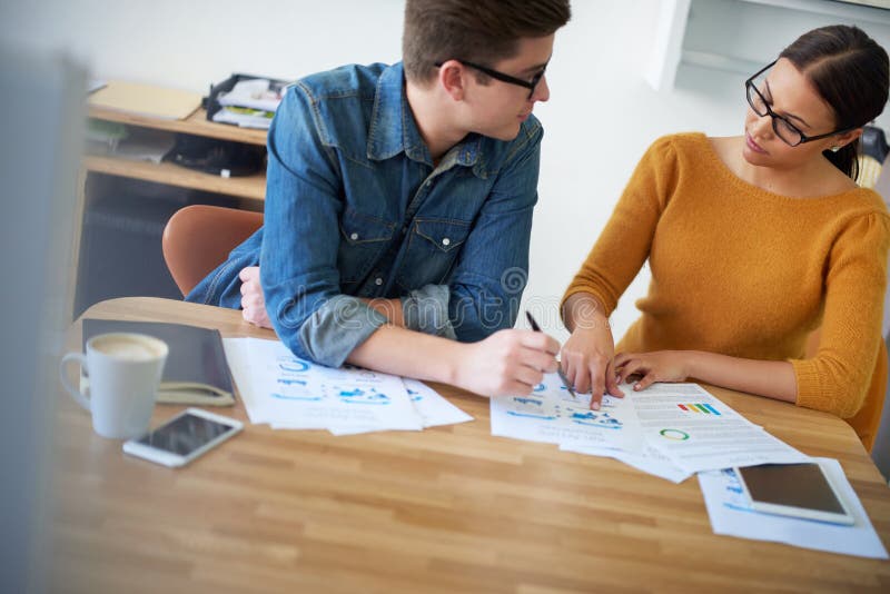Working Away at Their Latest Project. Two Colleagues Working Together ...
