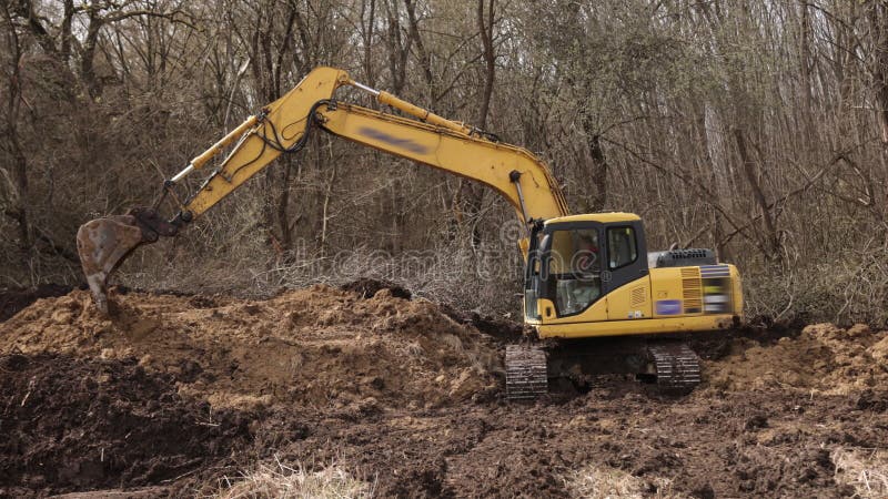 Bucket of Backhoe Digging Soil at Construction Site. Crawler Excavator ...