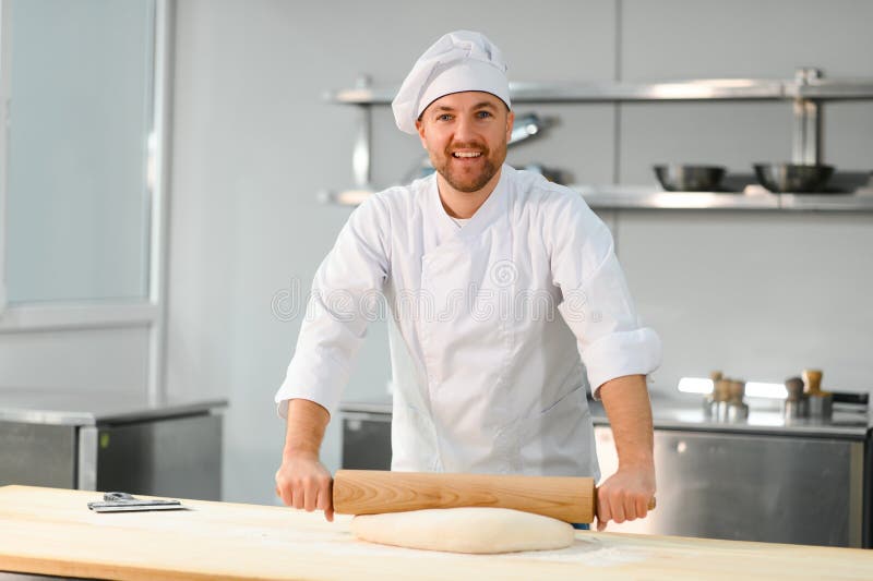 While Working in Bakery Using Rolling Pin, Male Cook Makes Thin Flat ...