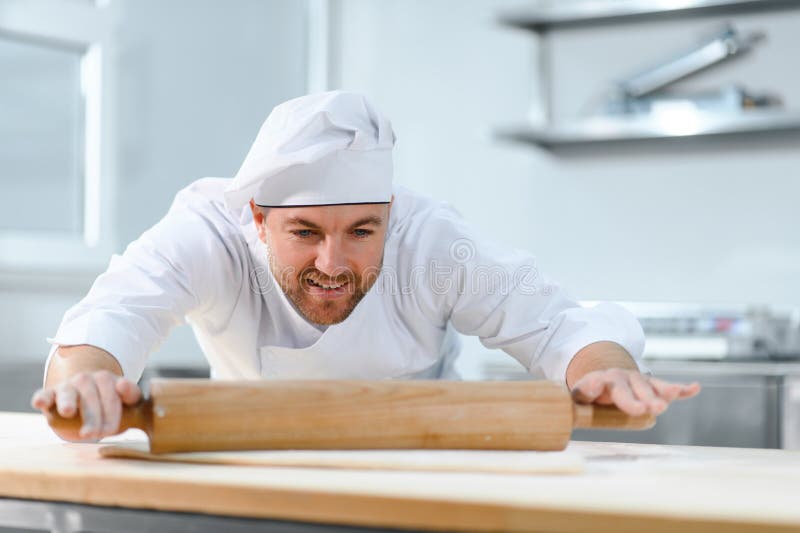 While Working in Bakery Using Rolling Pin, Male Cook Makes Thin Flat ...