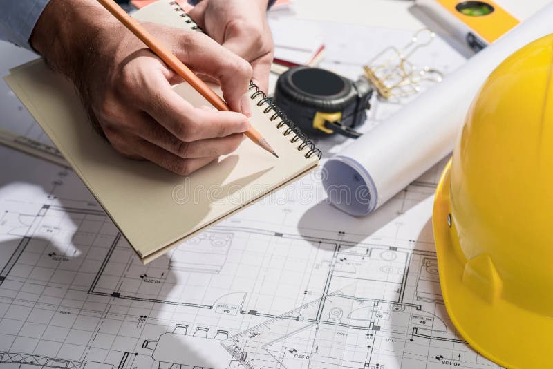 Working on Blueprints. Construction Project with Hands Writing O Stock ...