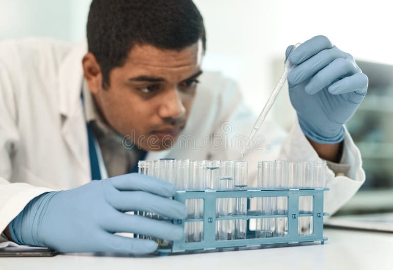 Working with Caution. a Young Scientist Working with Samples in a Lab ...