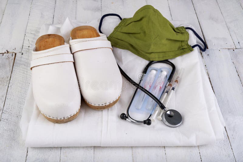 Working Clothes for a Medic. Medical Accessories on a White Table Stock ...