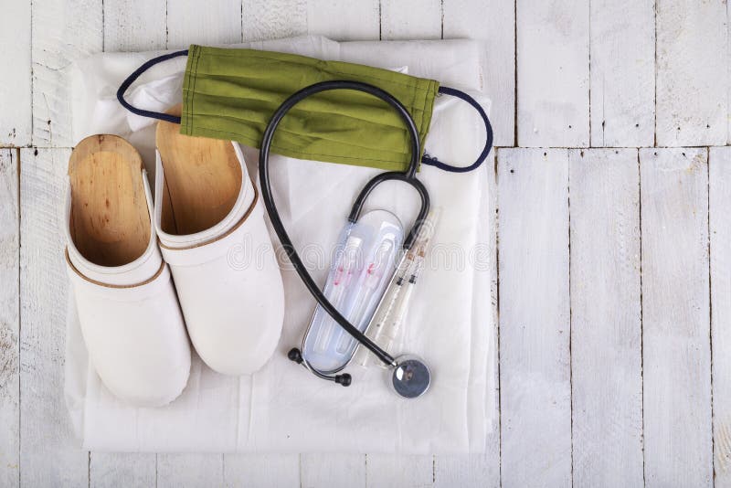 Working Clothes for a Medic. Medical Accessories on a White Table Stock ...