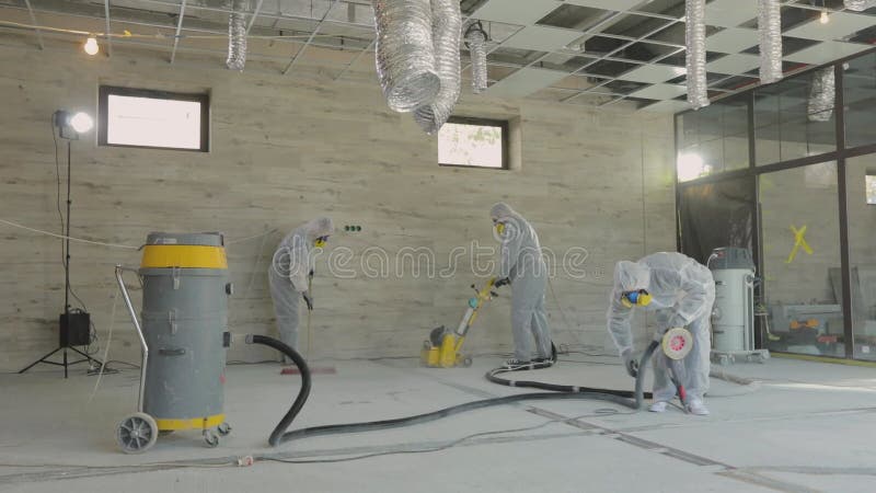 Concrete Floor Processing during Construction. Grinding a Concrete ...