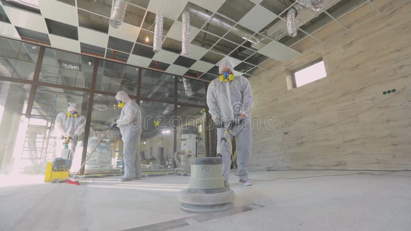 Concrete Floor Processing during Construction. Grinding a Concrete ...