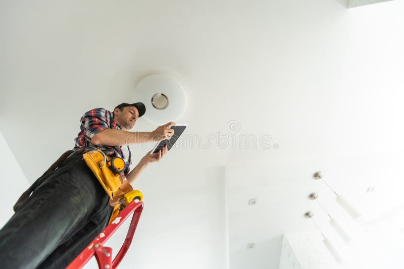 Working Contractor Electrician. Fixing the Light. Stock Image - Image ...