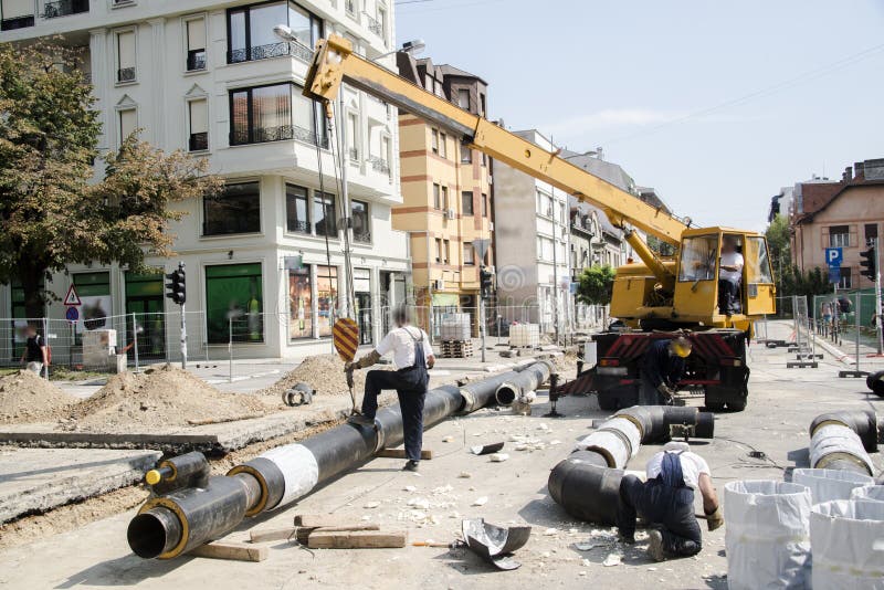 Working with a Crane and Lifting Pipes on the Building Stock Photo ...