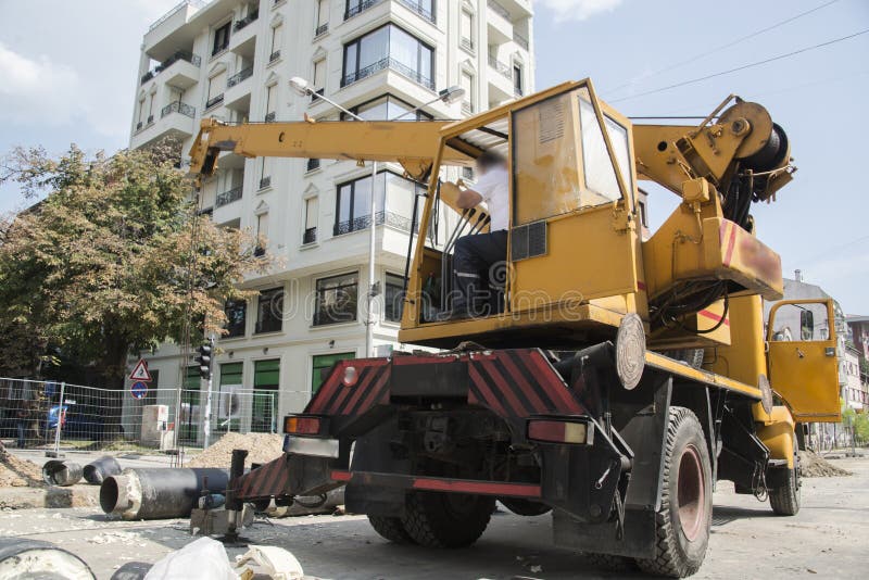 Working with a Crane and Lifting Pipes on the Building Stock Image ...