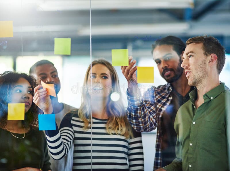 Working Creatively As a Unit. Colleagues Having a Brainstorming Session ...