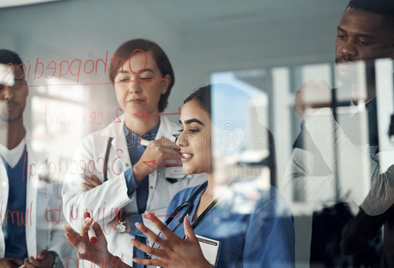 Working on a Cure. Shot a Group of Doctors Discussing Formulas in the ...