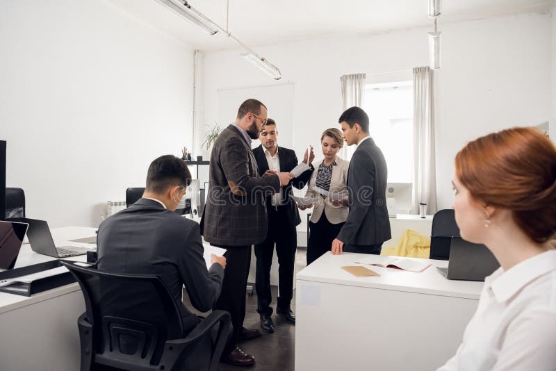Working Day in Office, Workers Stand and Look at the Documents Stock ...