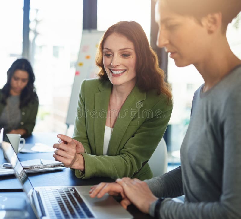 Working through the Details. a Group of Businesswomen Working in an ...