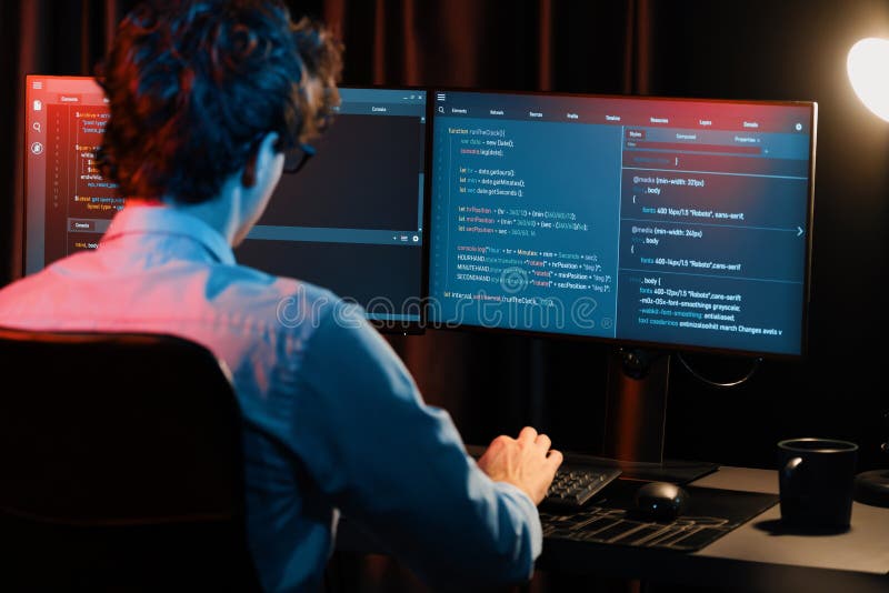 Working it Developer Concentrating Online Software at Neon Light Room. Gusher. Stock Image ...