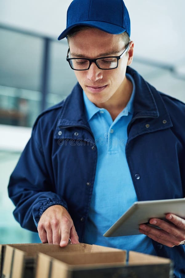 Working with a Digitized System. a Courier Using a Digital Tablet while ...