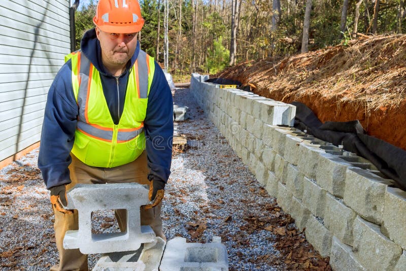 Construction Worker, am Mounting a Retaining Wall with Concrete Blocks ...