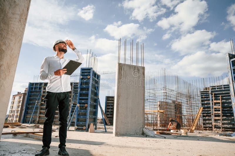 Working with Document. Man in Uniform is on the Construction Site Stock ...