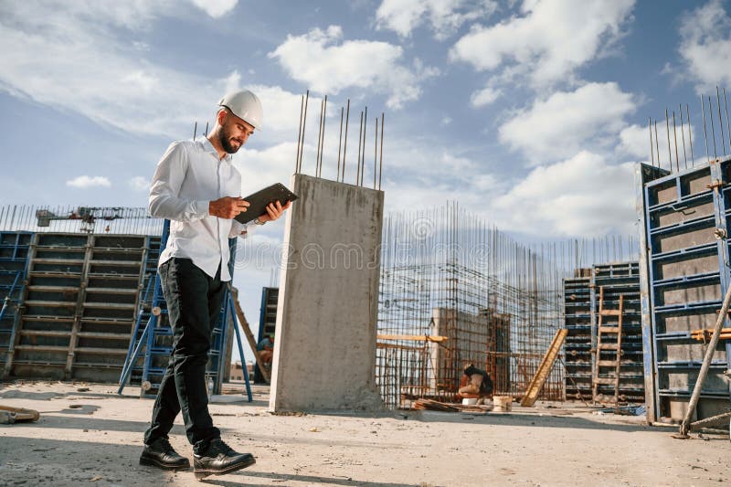 Working with Document. Man in Uniform is on the Construction Site Stock ...