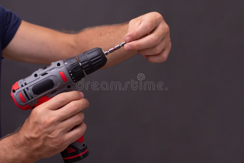 Working on an Electric Screwdriver on a Black Background Stock Photo ...