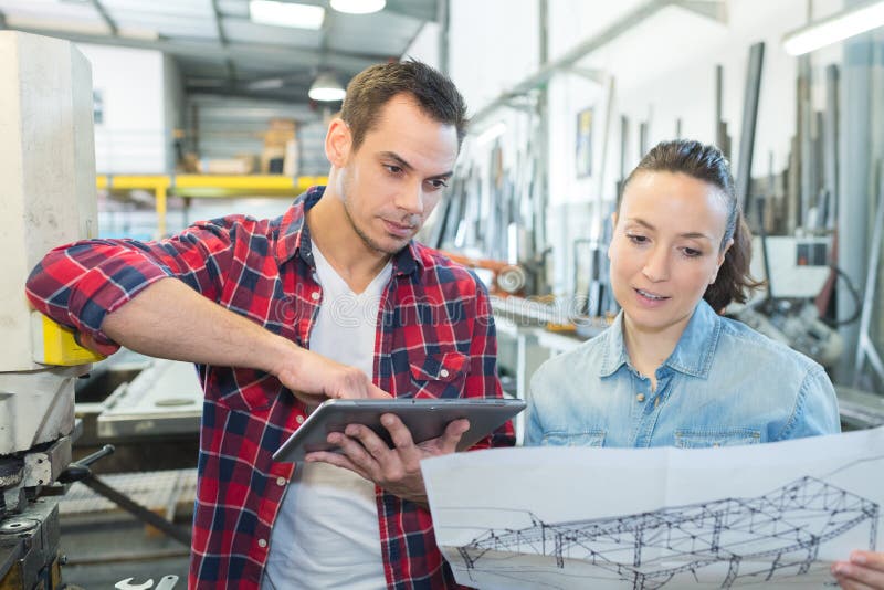 Working Engineers with Factory Plans Stock Image - Image of refinery ...
