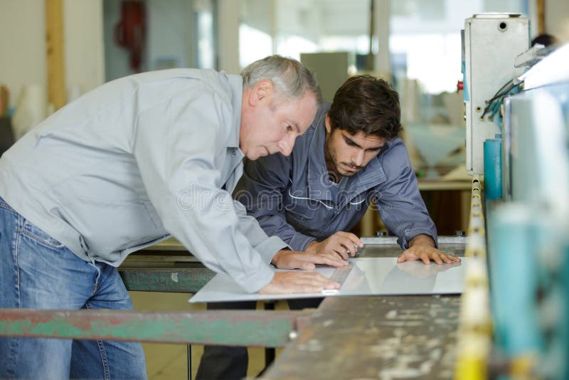 Working Engineers with Factory Plans Stock Image - Image of colleague ...