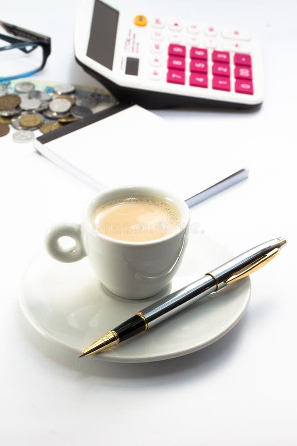 Working Environment with Calculator Pen Notebook and a Cup of Coffee ...