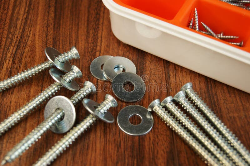 Screws for Concrete and Metal Washers on a Wooden Surface. Working ...
