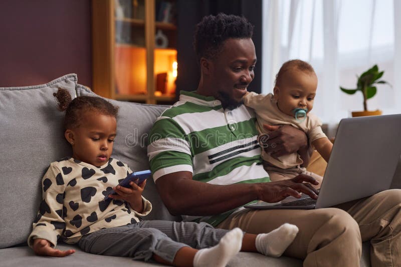 Working Father with Two Children Using Laptop and Smiling Enjoying ...