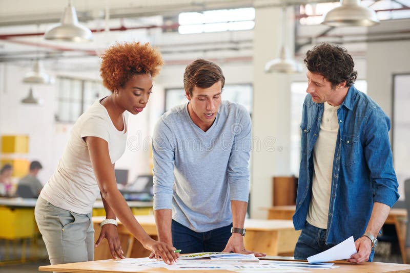 Working on the Finer Details. a Group of Colleagues Collaborating with ...