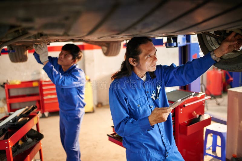 Working in garage stock image. Image of people, auto - 74528969