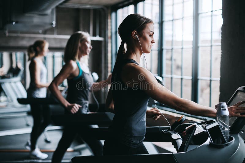Working at a Good Pace. Three Attractive and Athletic Women Working Out ...