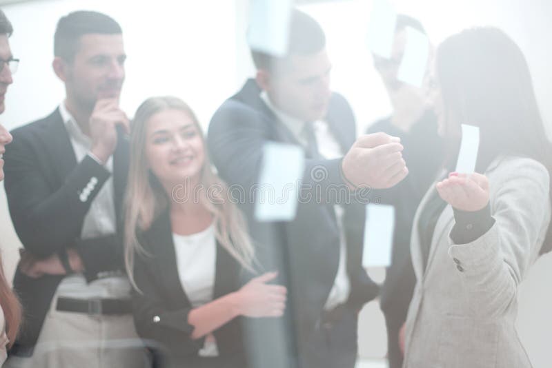 Working Group Discussing Sticky Notes on Glass Wall Stock Photo - Image ...