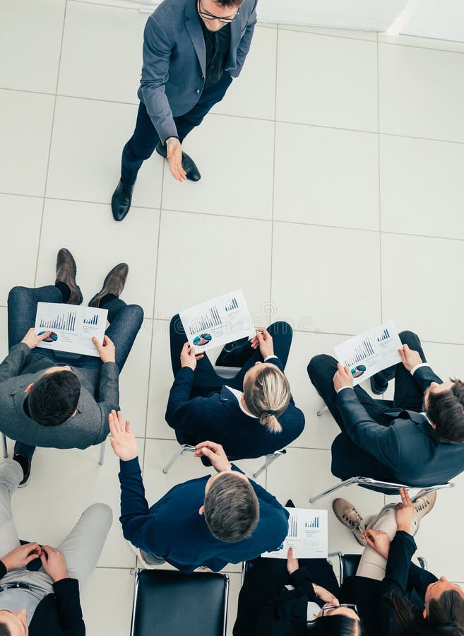 Working Group with Financial Documents Sitting in the Conference Room ...