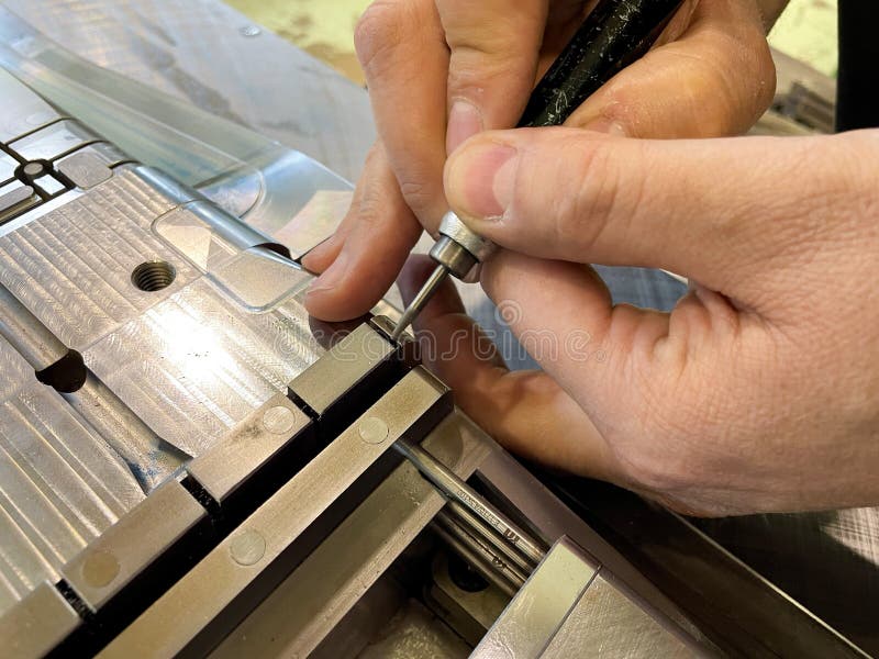 Working Hands, Finishing with a Precision Tool on a Steel Mould Stock ...