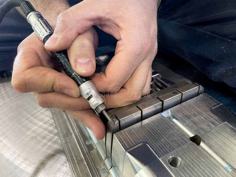 Working Hands, Finishing with a Precision Tool on a Steel Mould Stock ...