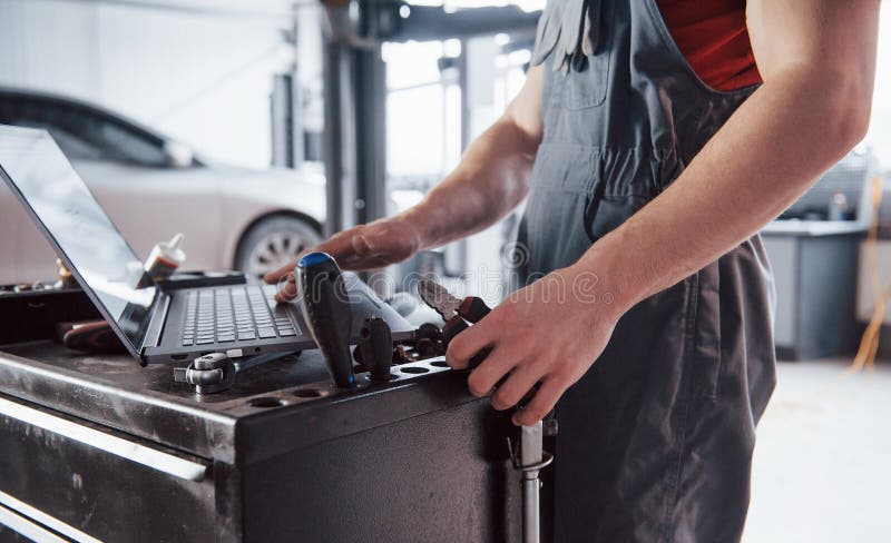 Working Hands. Man Indoors in Uniform Using Laptop for His Job for ...
