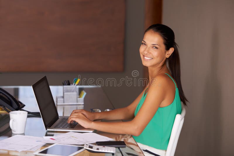 Working Hard and Loving the Results. a Beautiful Young Woman Typing a ...