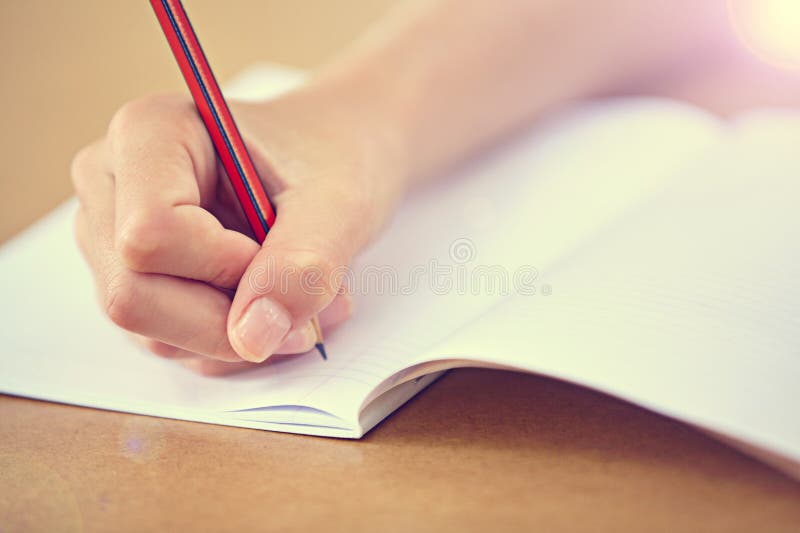 Working Hard at School. a Cropped Closeup Image of a Child Writing in a ...