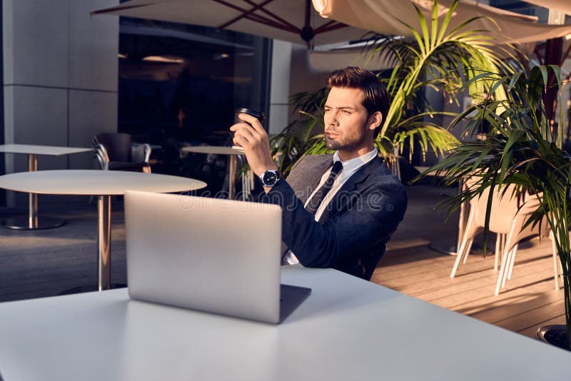 Working Hard To Achieve Success. Thoughtful Young Modern Man Using ...