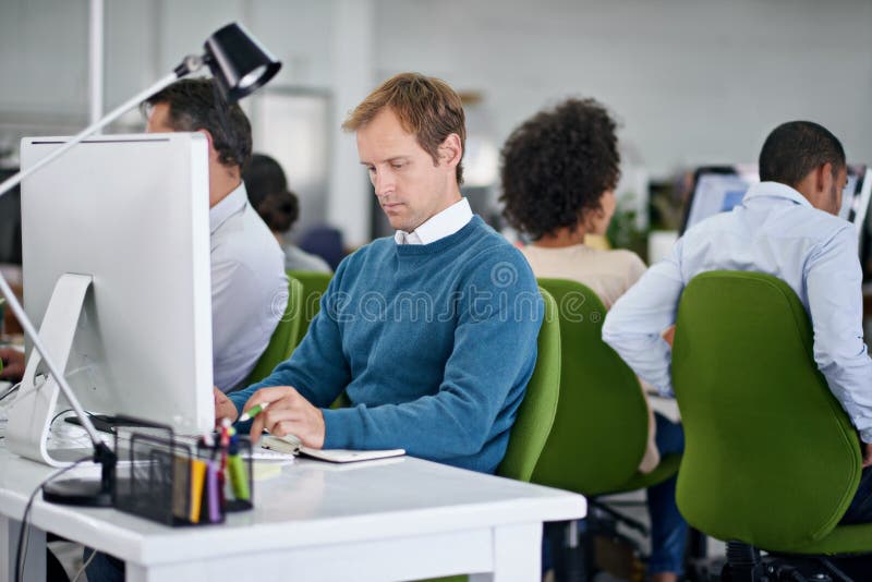 Working Hard To Meet His Deadline. a Group of Creative Businesspeople ...