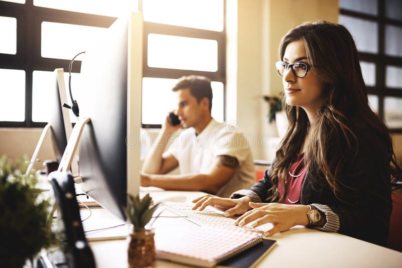Working Her Magic. a Businesswoman Working on a Computer in an Modern ...