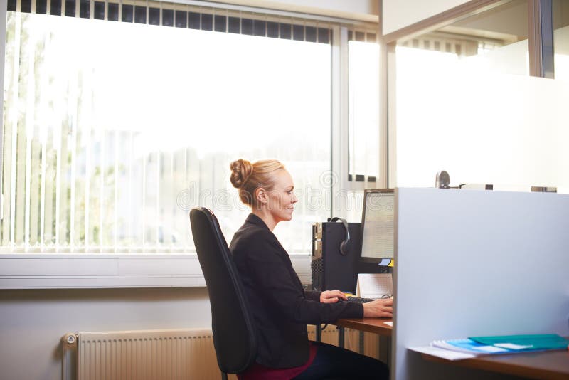 Working on Her Pc. an Attractive Businesswoman Using Her Work Computer ...