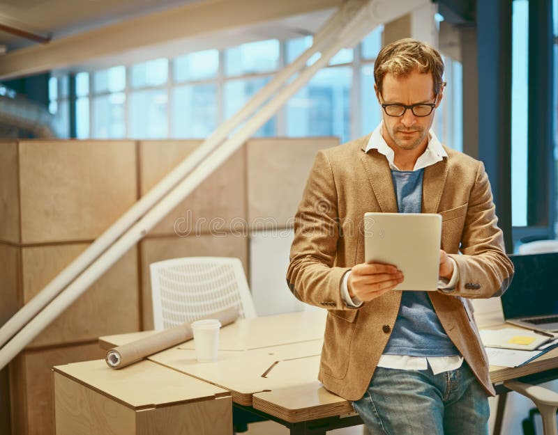 Working on His Designs. a Handsome Male Designer Working on a Tablet in ...