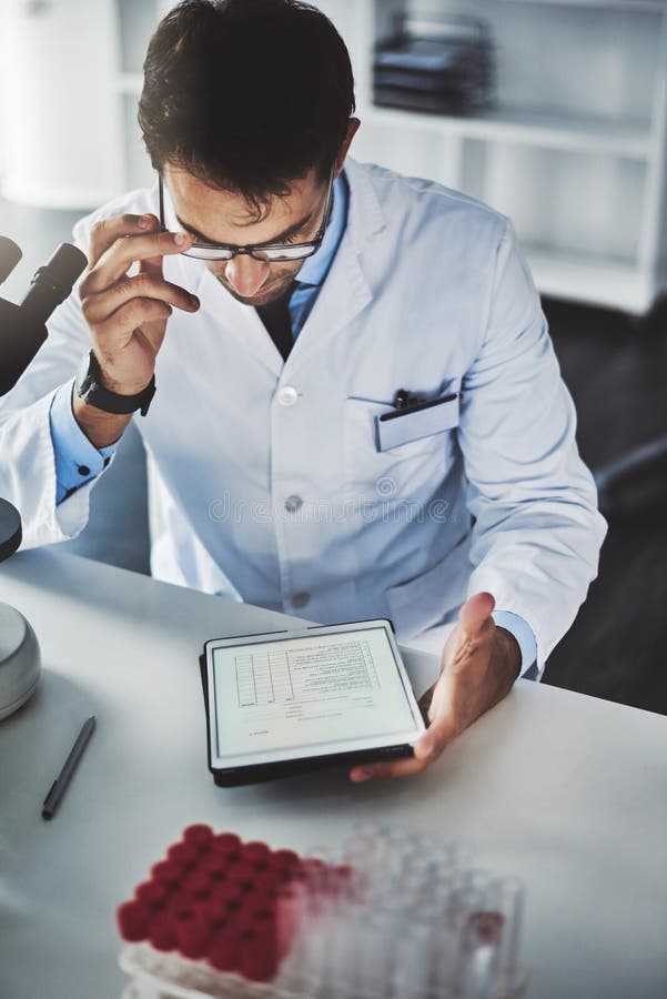 Working on His Latest Discovery. a Scientist Using a Digital Tablet ...